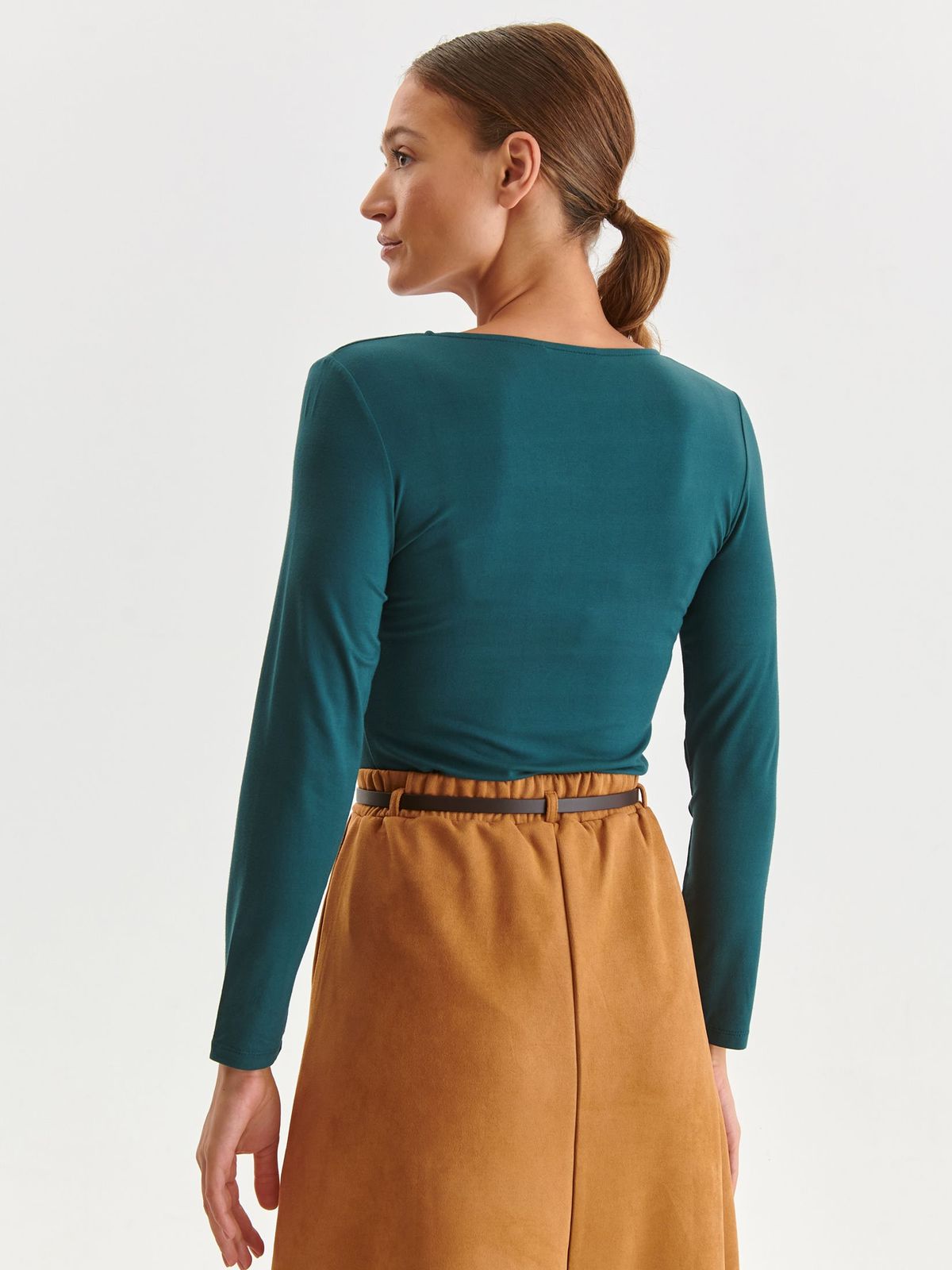 Green women`s blouse tented from elastic fabric with rounded cleavage Green women`s blouse tented from elastic fabric with rounded cleavage